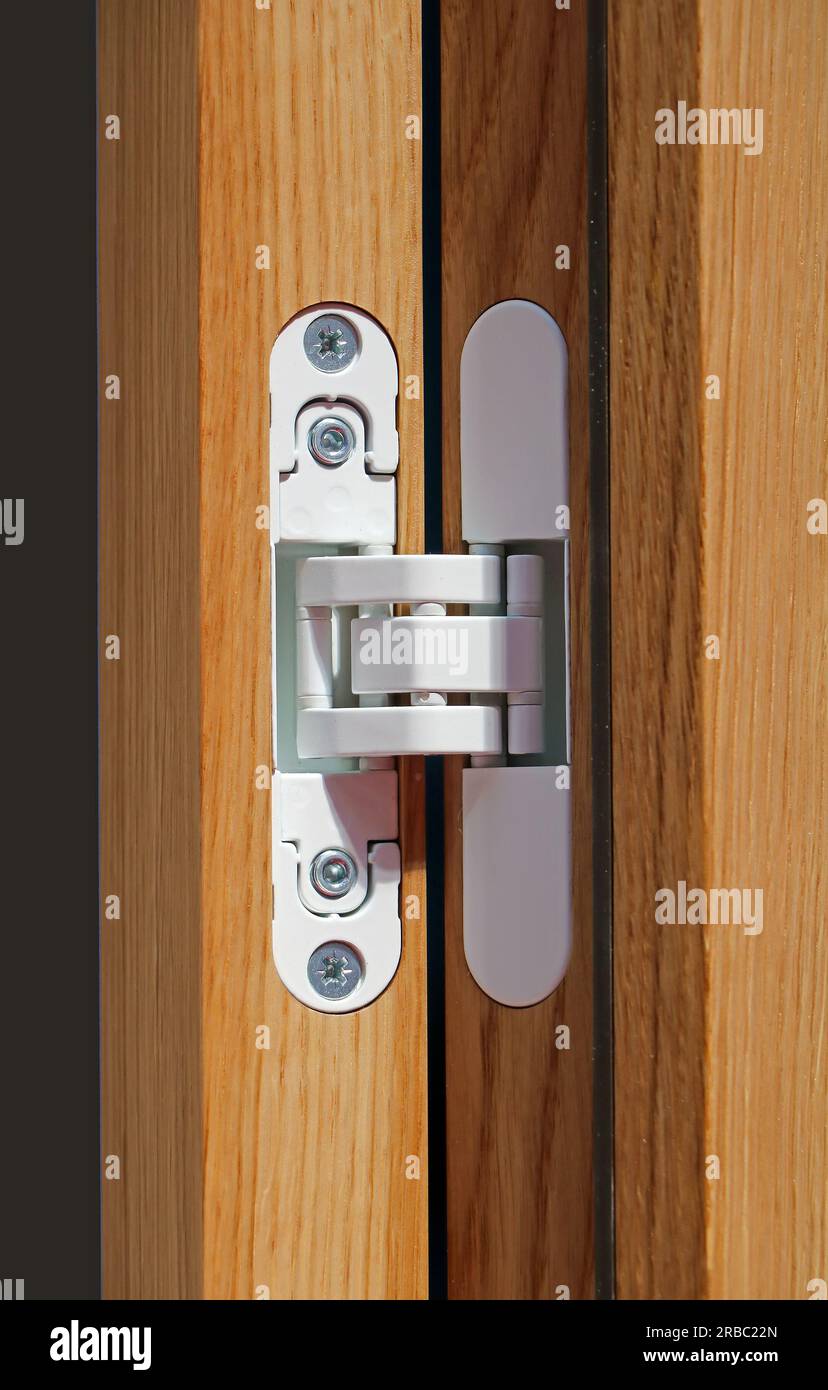 Metal hinge handle in wooden window frame Stock Photo - Alamy