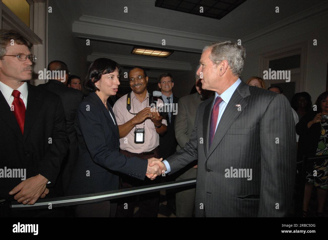 Department staff greeting President George W. Bush, from behind rope ...