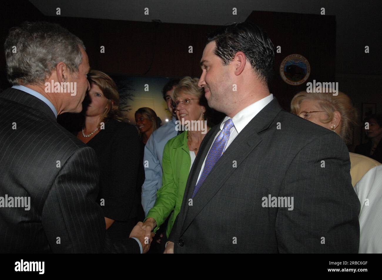 Department staff greeting President George W. Bush, from behind rope ...