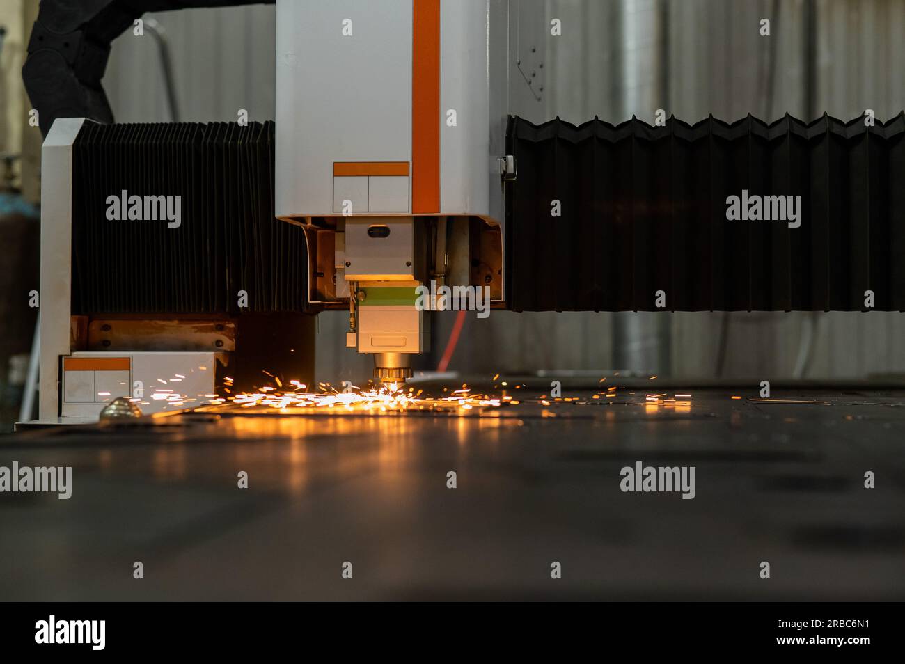 CNC machine. Laser cutting of metal. Sparks Stock Photo - Alamy