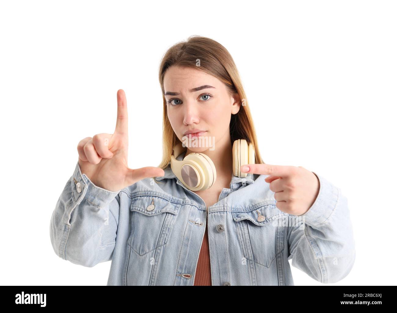Sad young woman showing loser gesture on white background Stock Photo ...