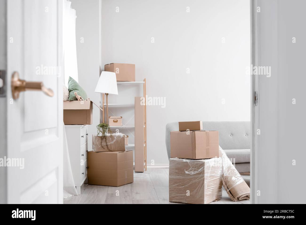 Cardboard boxes in living room on moving day, view from open door Stock ...