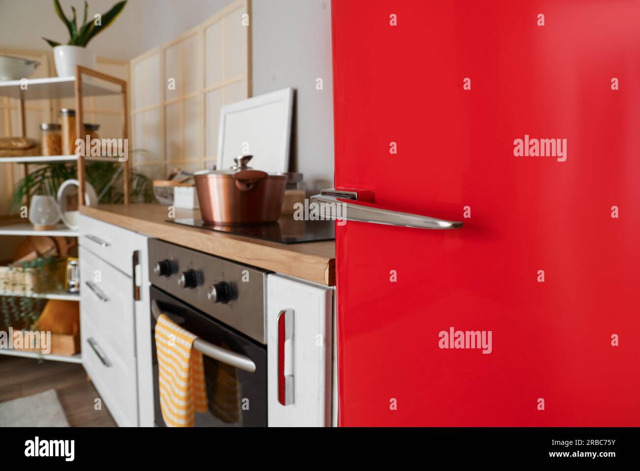 Interior of kitchen with red fridge, counters and shelving unit ...