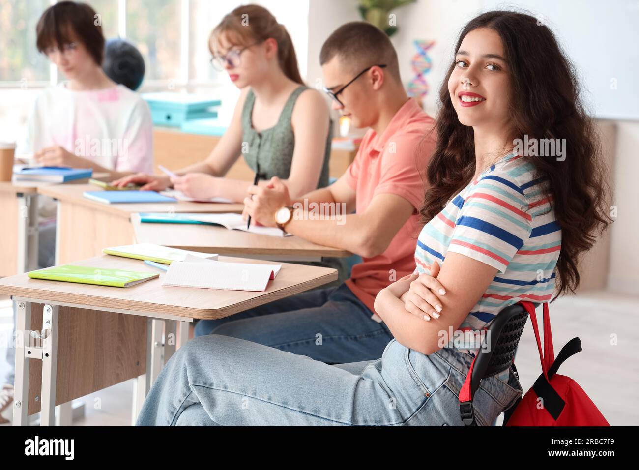Female student with her classmates having lesson in classroom Stock ...