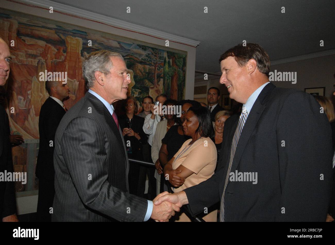 Department staff greeting President George W. Bush, from behind rope ...
