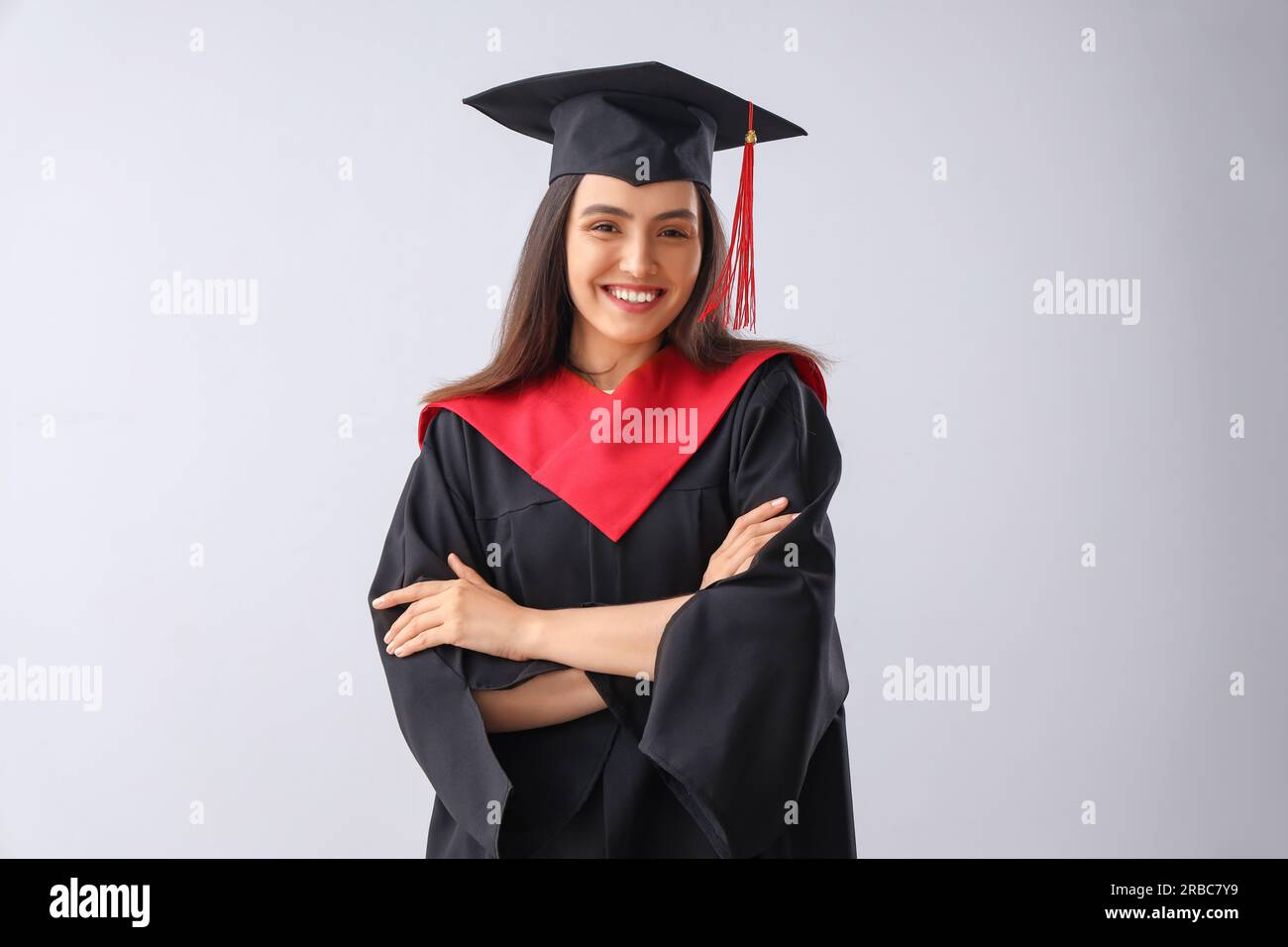 Female graduate student on light background Stock Photo - Alamy
