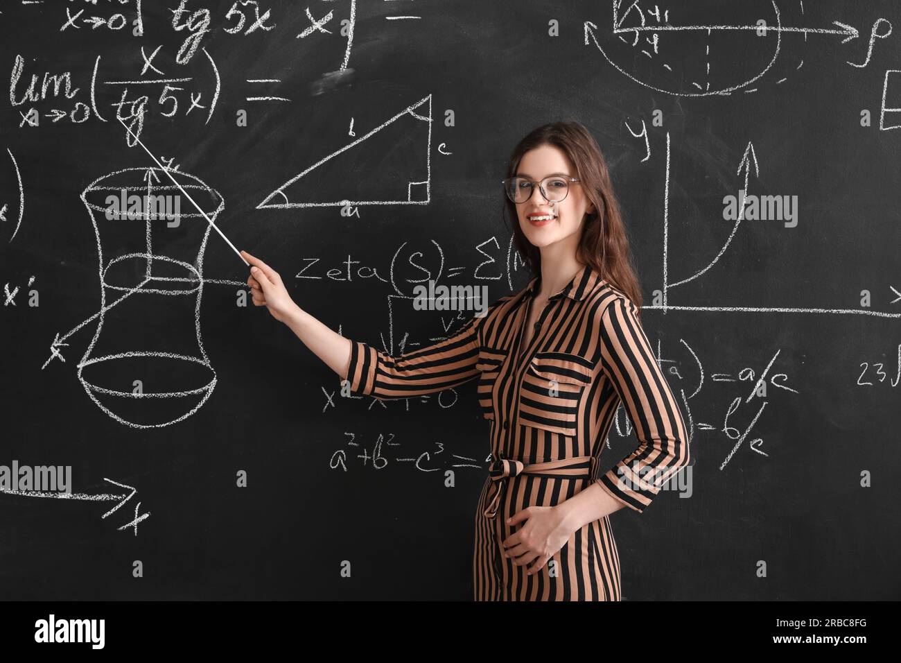 Female Math teacher conducting lesson in classroom Stock Photo - Alamy