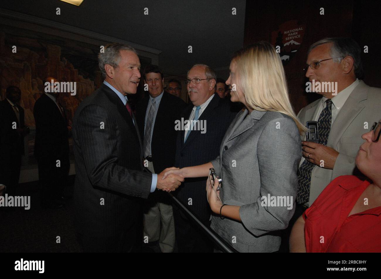 Department staff greeting President George W. Bush, from behind rope ...