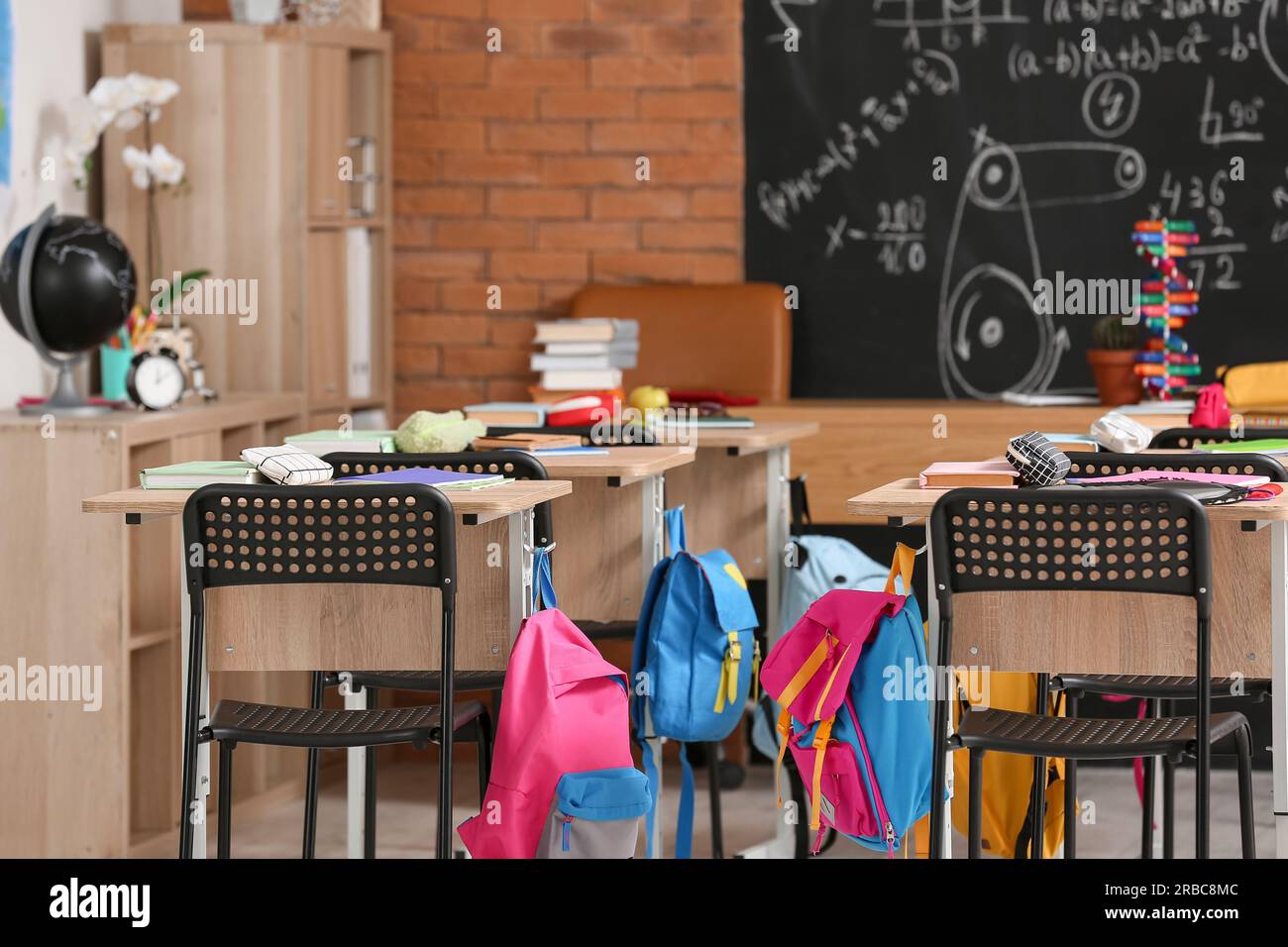 Backpacks in classroom hi-res stock photography and images - Alamy