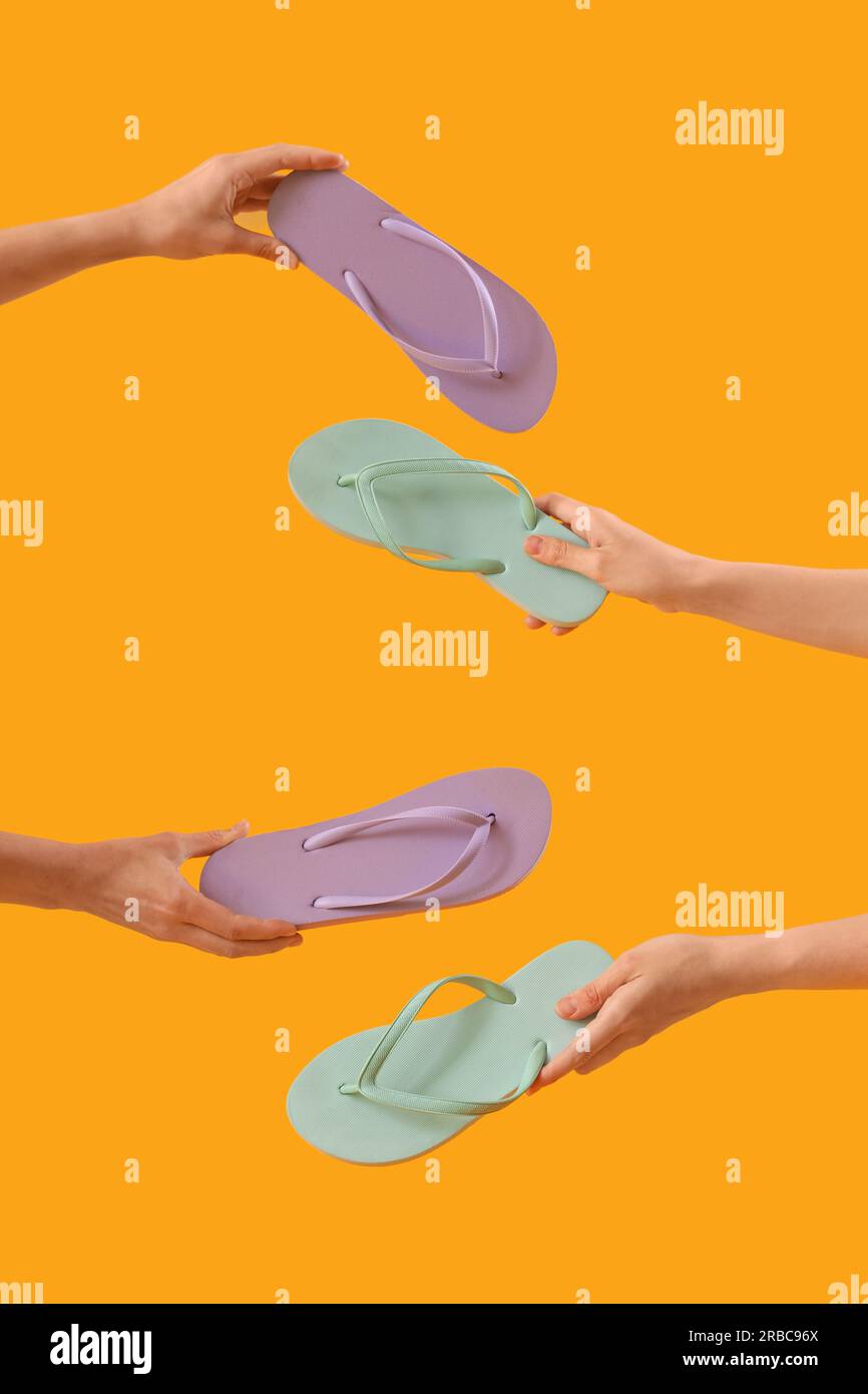 Hands with flip-flops on yellow background Stock Photo - Alamy