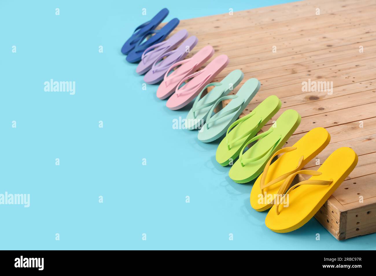 Many different flip-flops on blue background Stock Photo - Alamy