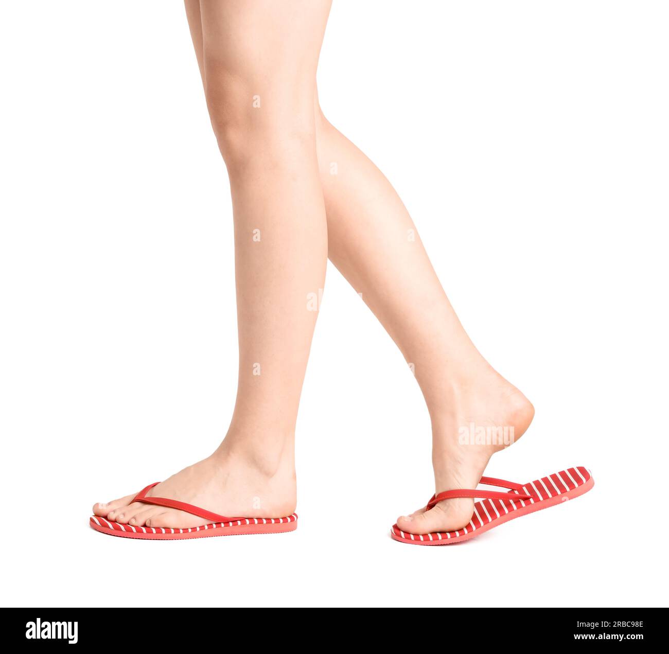Female legs in flip-flops on white background Stock Photo - Alamy