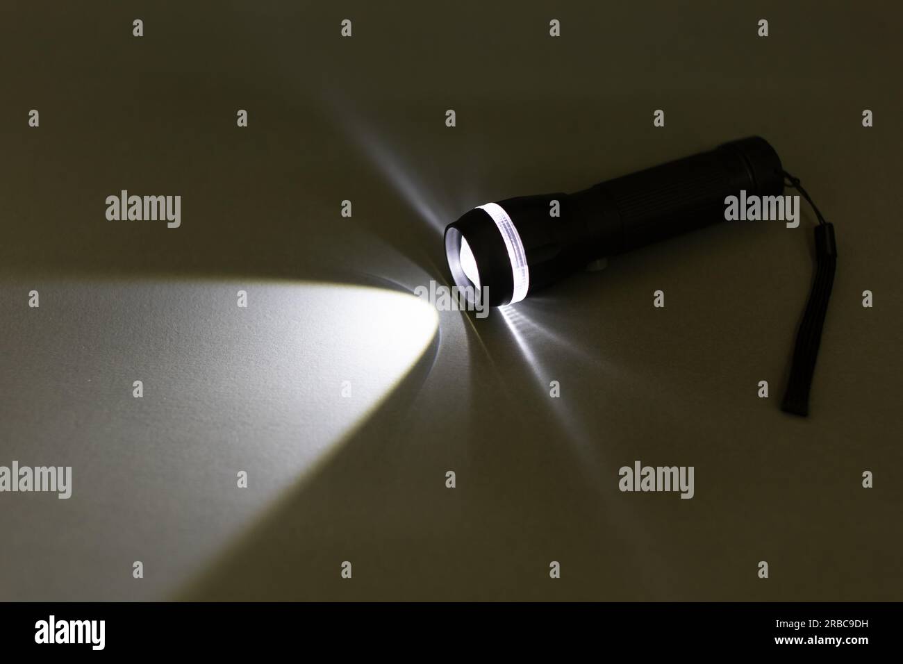 Black torch or flashlight with beam of light Stock Photo - Alamy