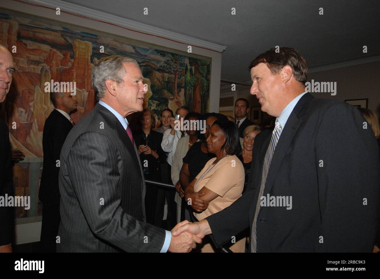 Department staff greeting President George W. Bush, from behind rope ...