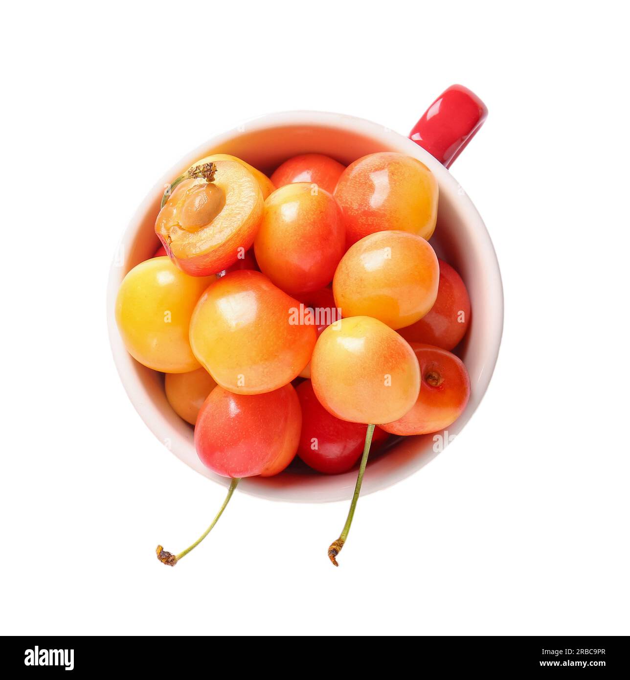 Cup with sweet yellow cherries on white background Stock Photo - Alamy