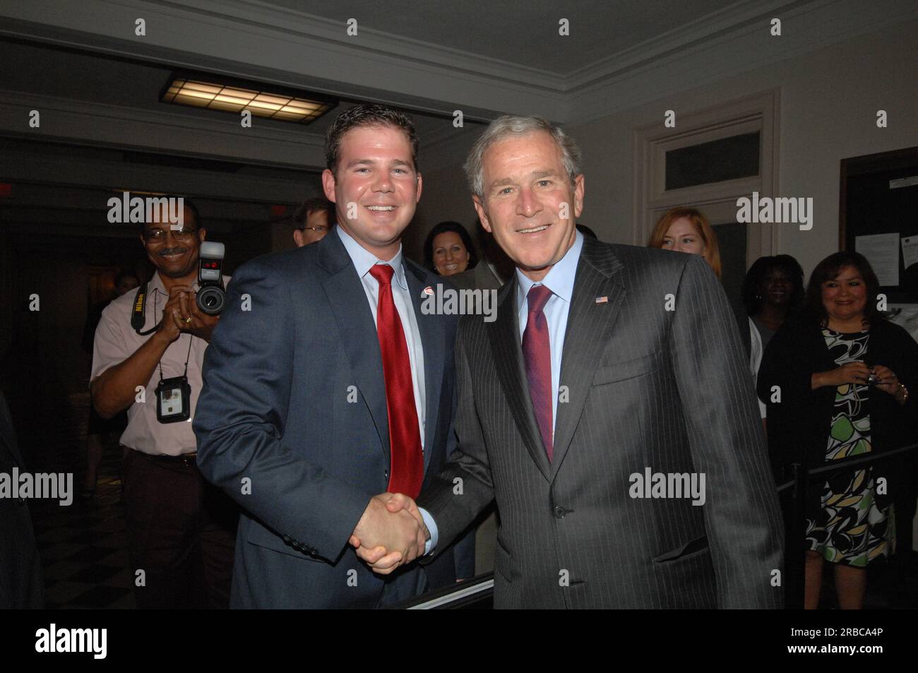 Department staff greeting President George W. Bush, from behind rope ...