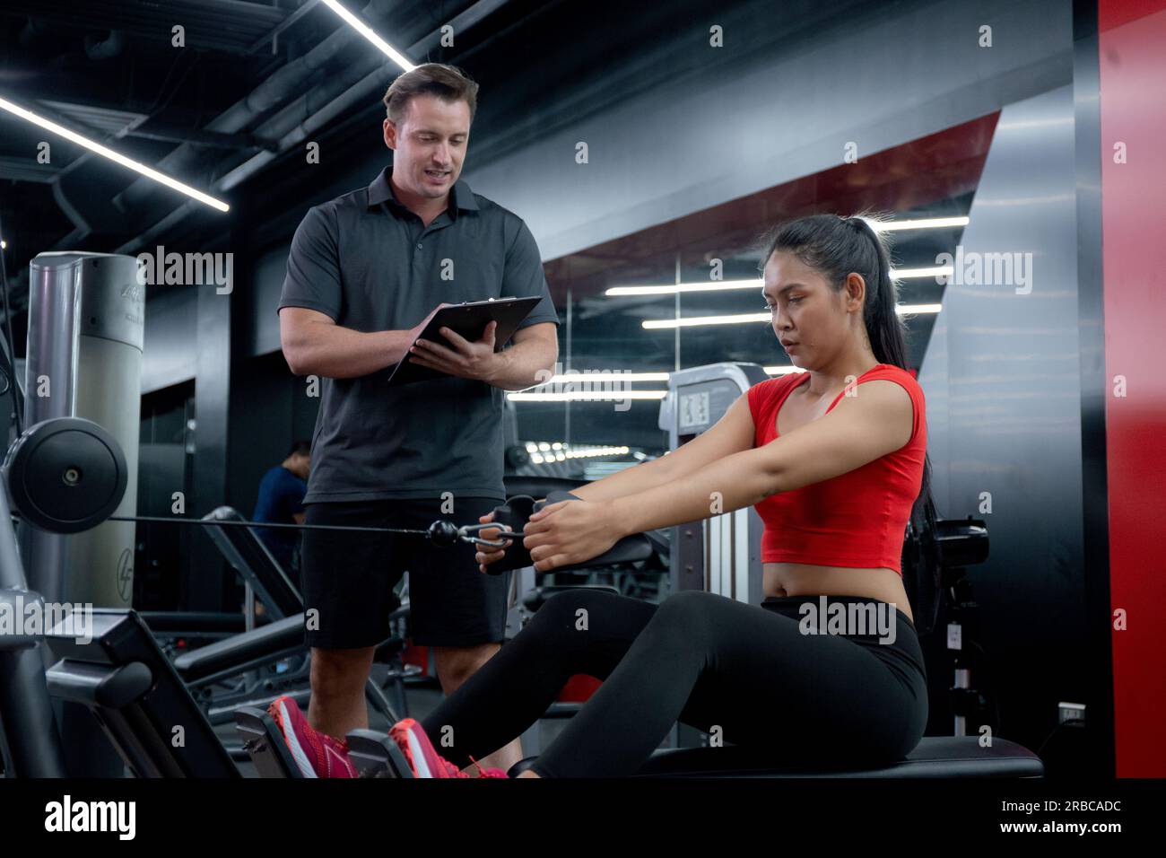 Coach man guiding workout with hands muscles stretch with equipment ...