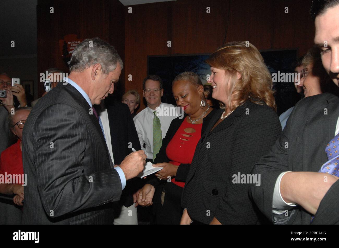Department staff greeting President George W. Bush, from behind rope ...