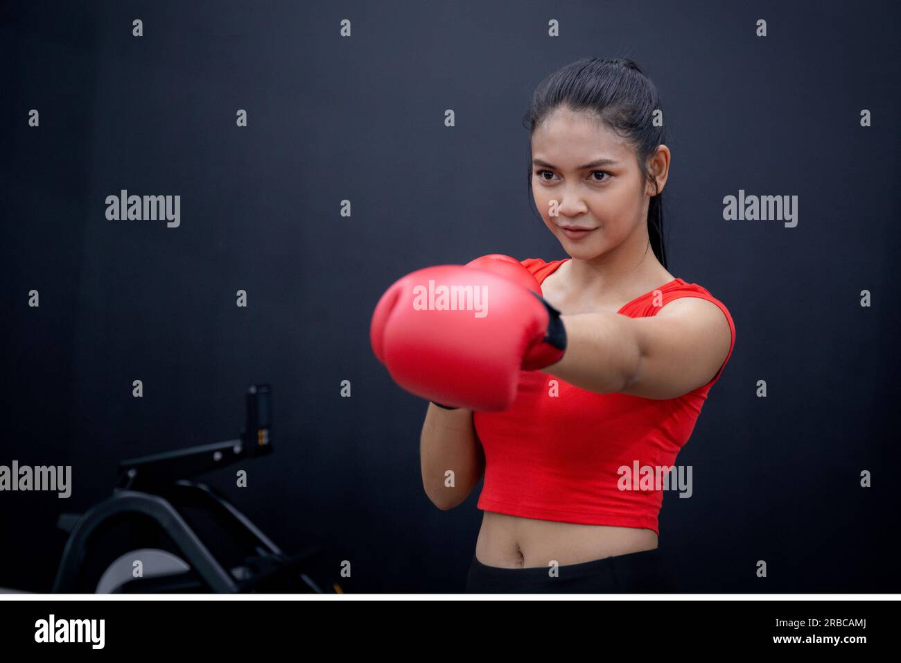 Determination of young asian woman having motivation boxing in fitness ...