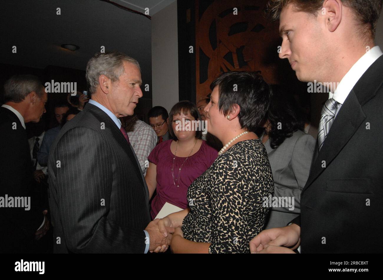 Department staff greeting President George W. Bush, from behind rope ...