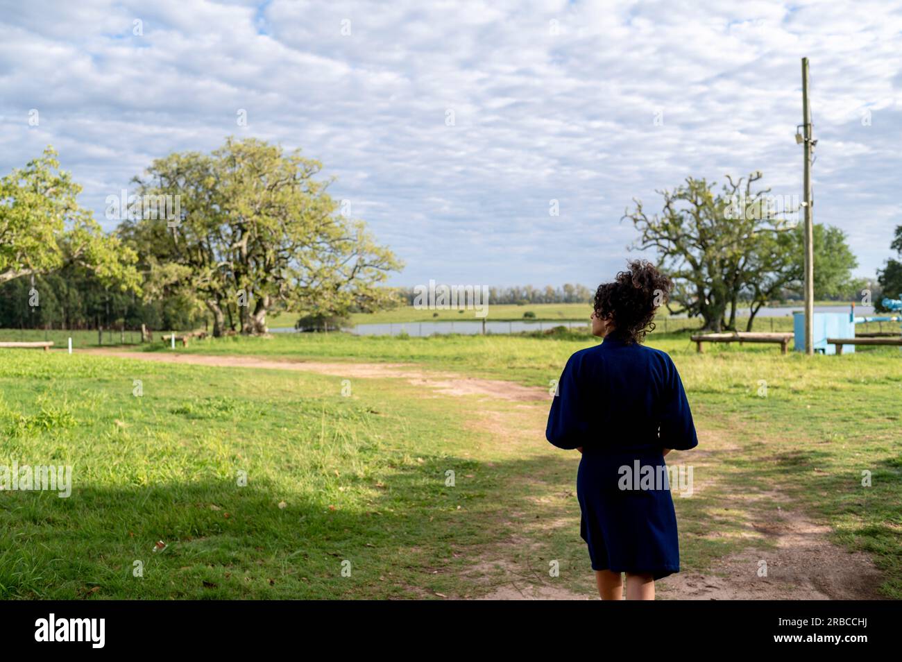 Woman walking outdoors in the field Stock Photo - Alamy