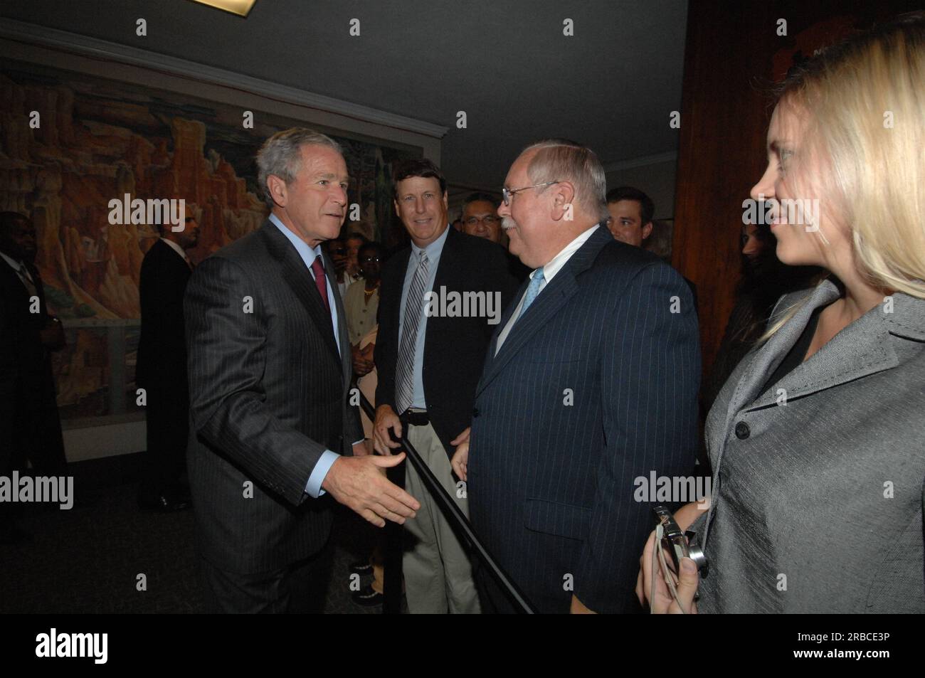 Department staff greeting President George W. Bush, from behind rope ...