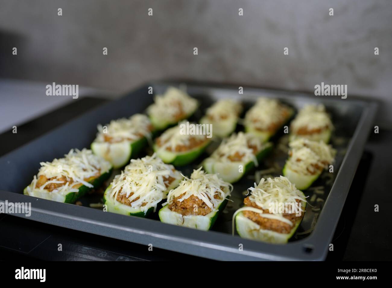 Raw zucchini stuffed with minced meat prepared for baking Stock Photo ...