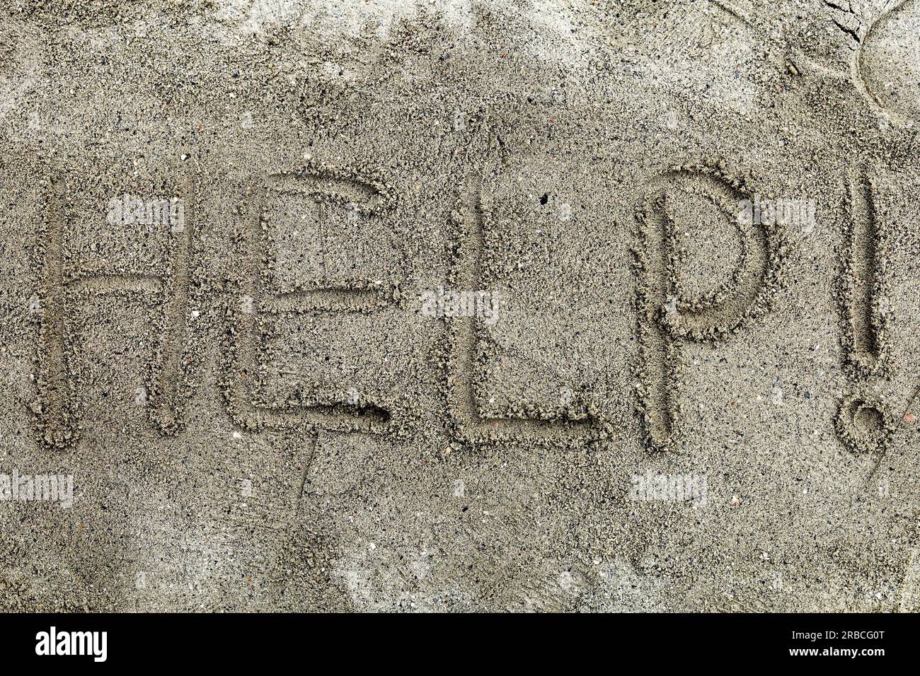 The word help written in the sand on the beach. The concept of a call ...