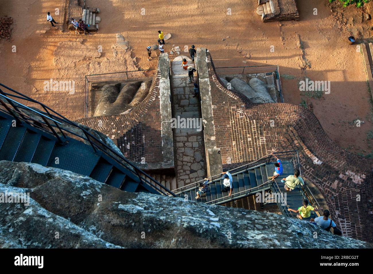 Tourists descend on the stairway from the summit of Sigiriya Rock ...
