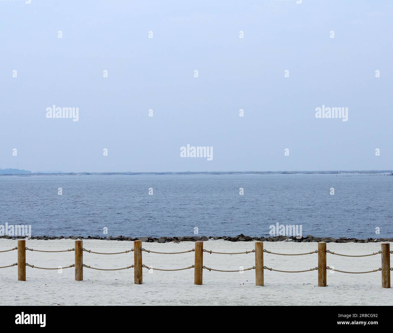 Pole with rope on sand at the beach Stock Photo - Alamy
