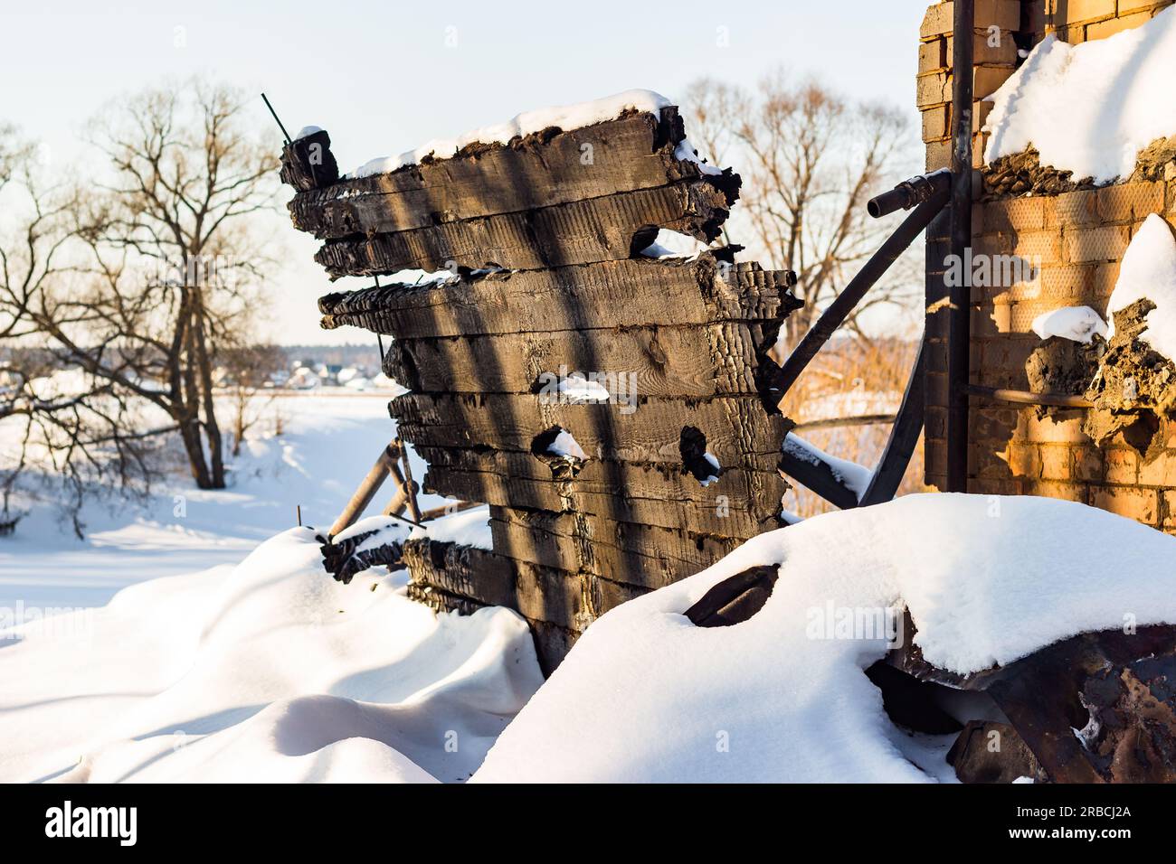Remains of a charred wooden wall of a burnt house, the ruins of a ...