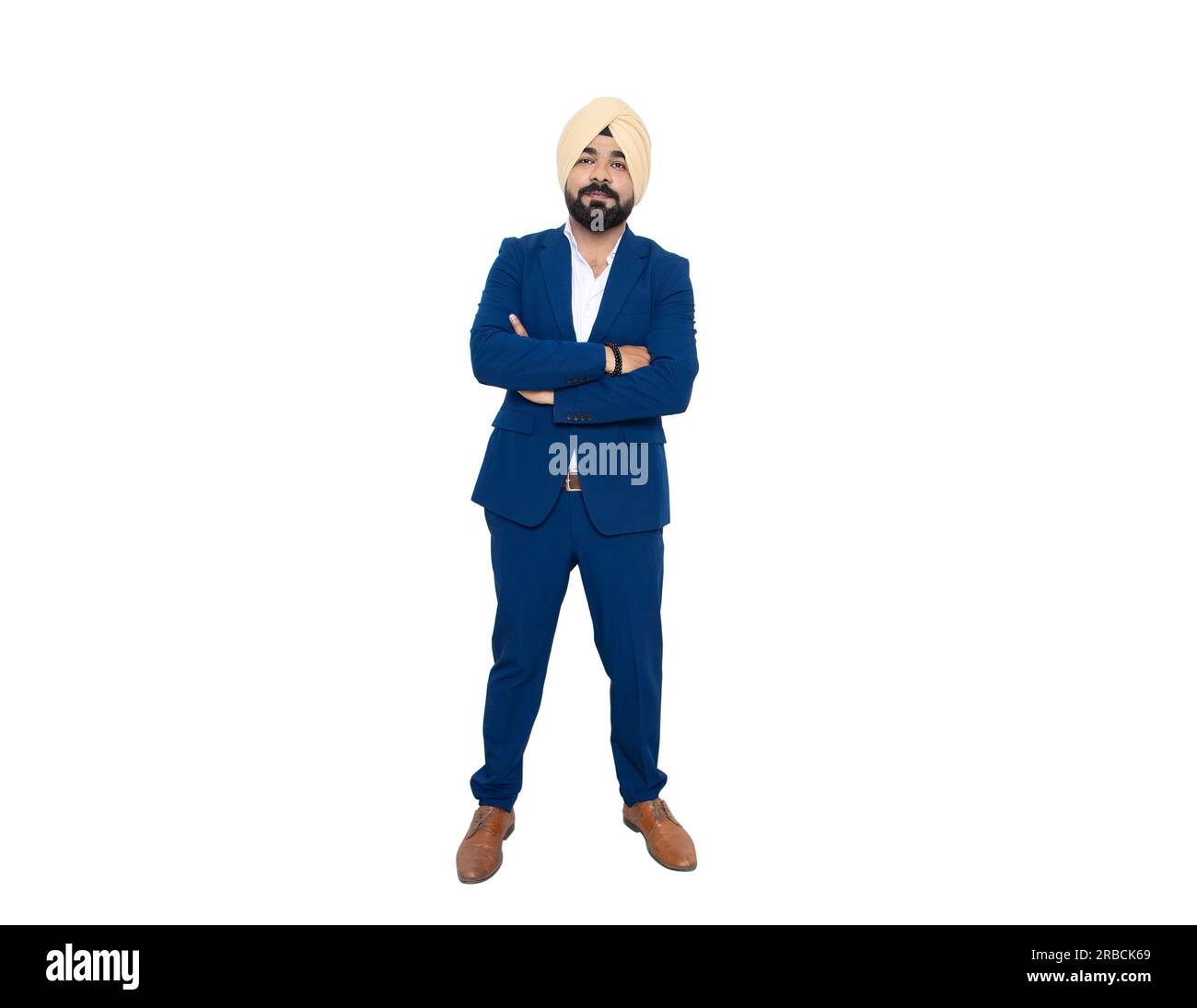 Happy young indian sikh businessman wearing suit standing cross arms ...