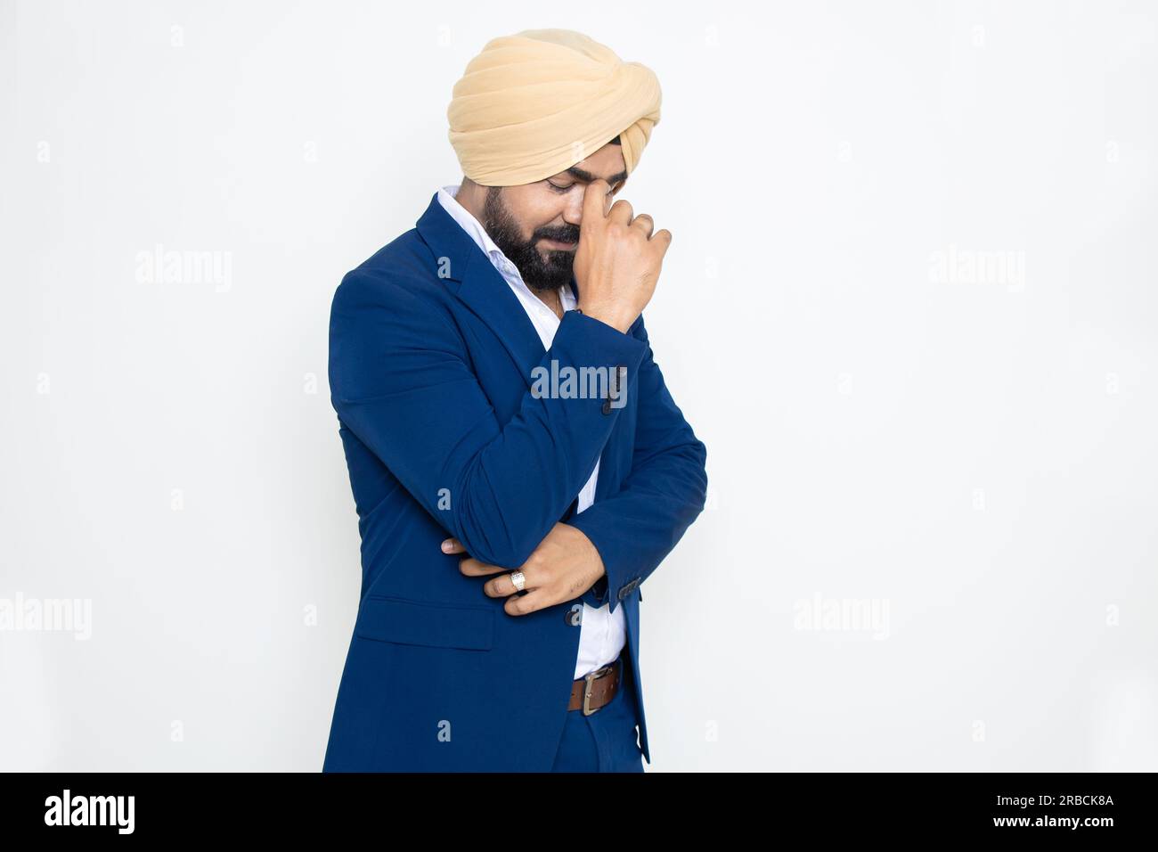 stressed indian sikh businessman wearing suit standing isolated over ...