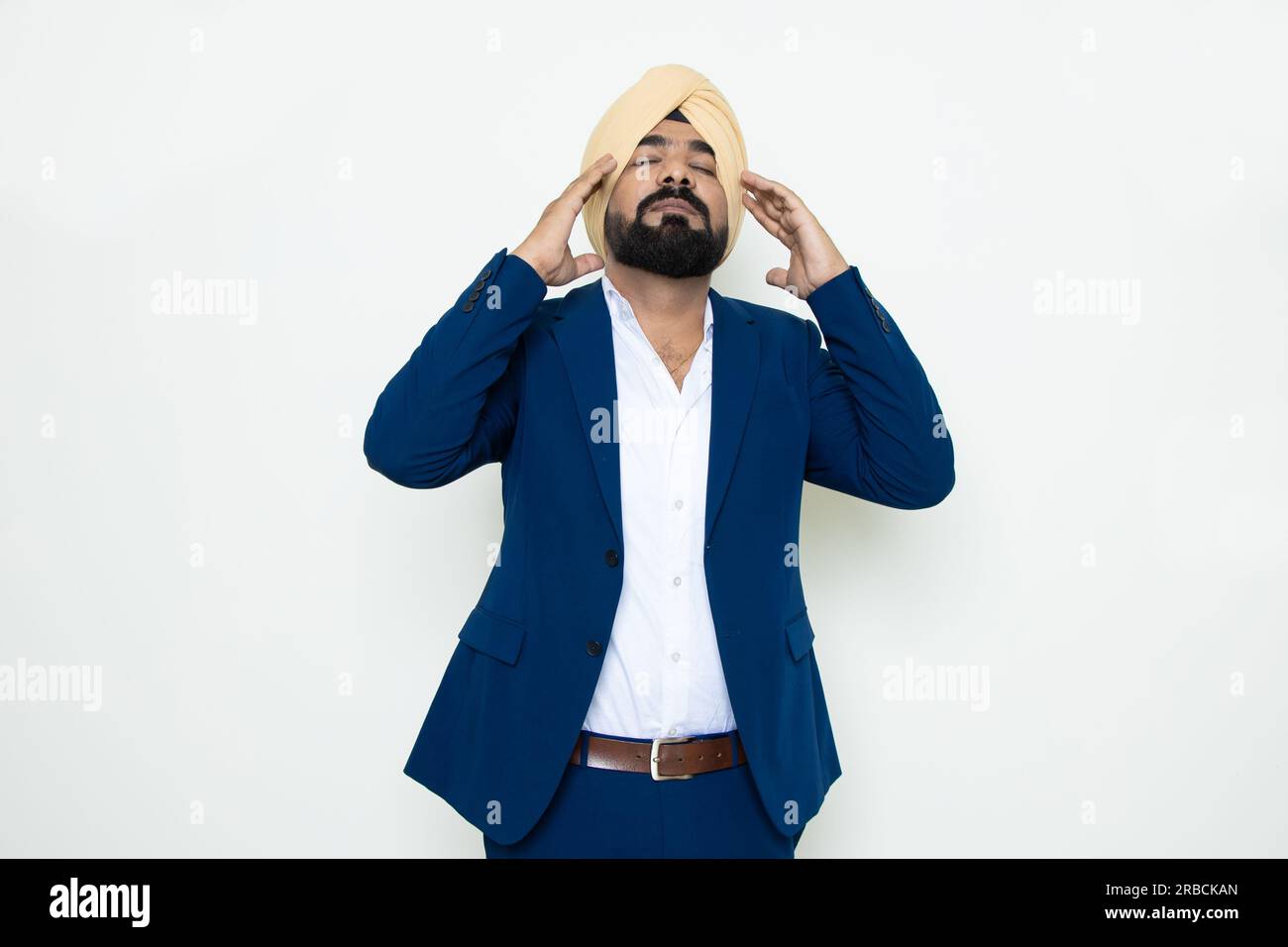stressed indian sikh businessman wearing suit standing isolated over ...