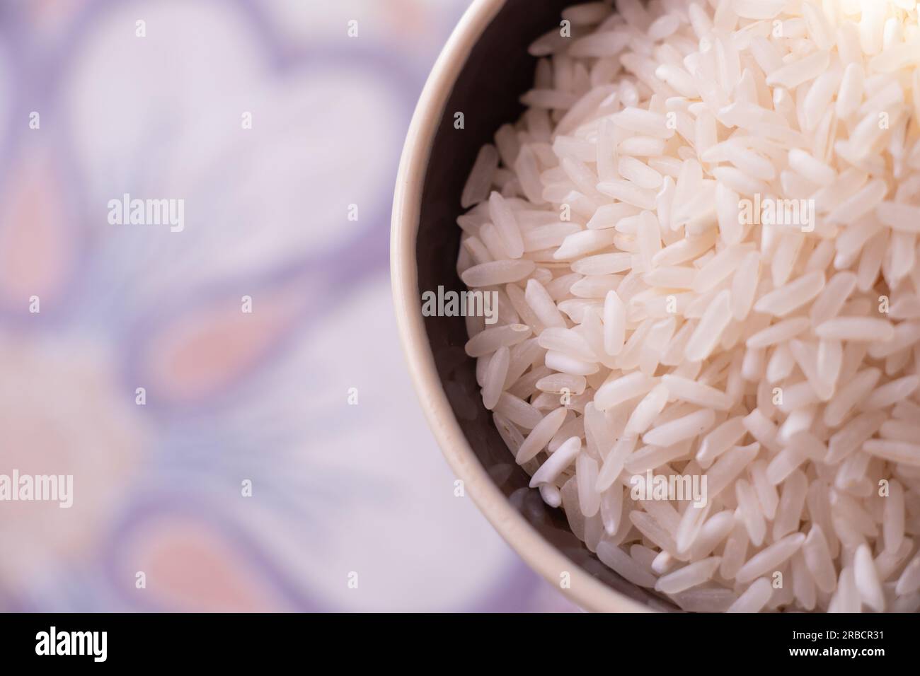 a full cup of raw long grain rice on a table Stock Photo - Alamy