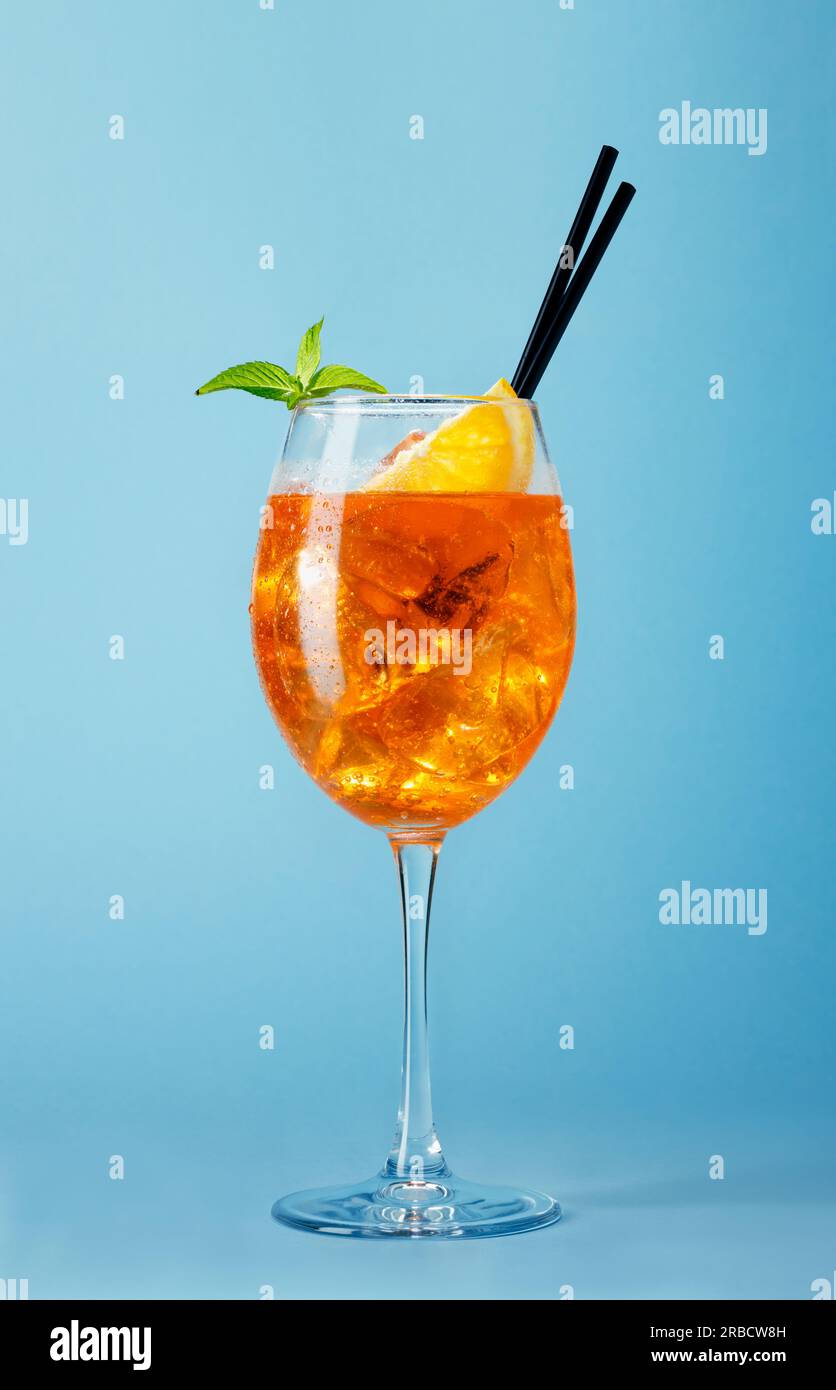 glass of aperol spritz cocktail with straw on blue background Stock ...