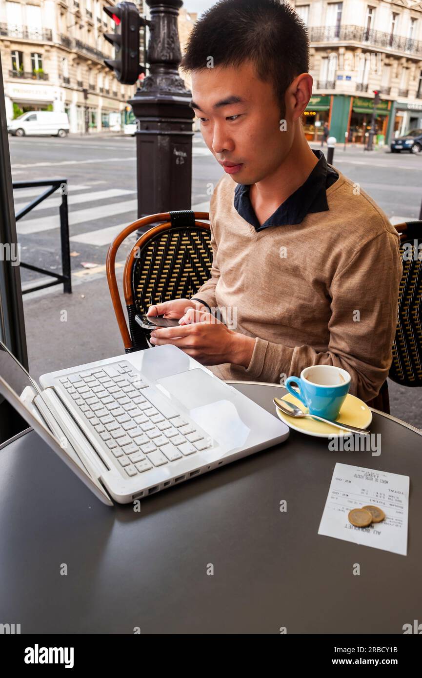Paris, France, Chinese Tourist Using SMart iPhone and Personal COmputer ...
