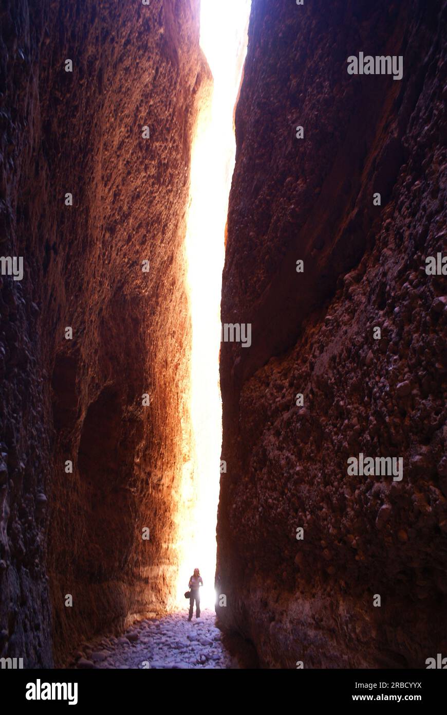 Person standing in the sunbeam shining into the narrow cleft between ...