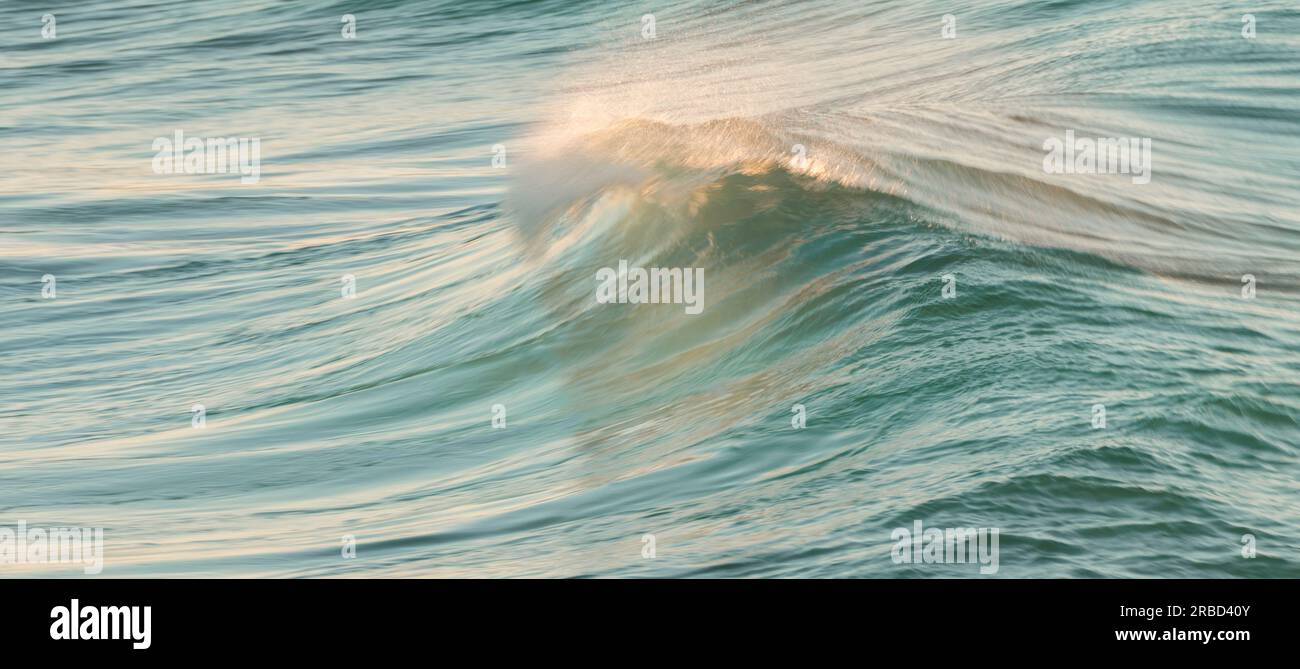 Ocean waves with sunlight shining on the splashing water Stock Photo ...