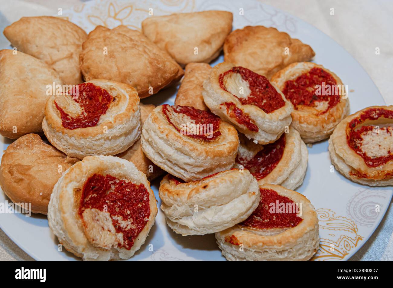 Rustic sweets of puff pastry with tomato sauce Stock Photo - Alamy