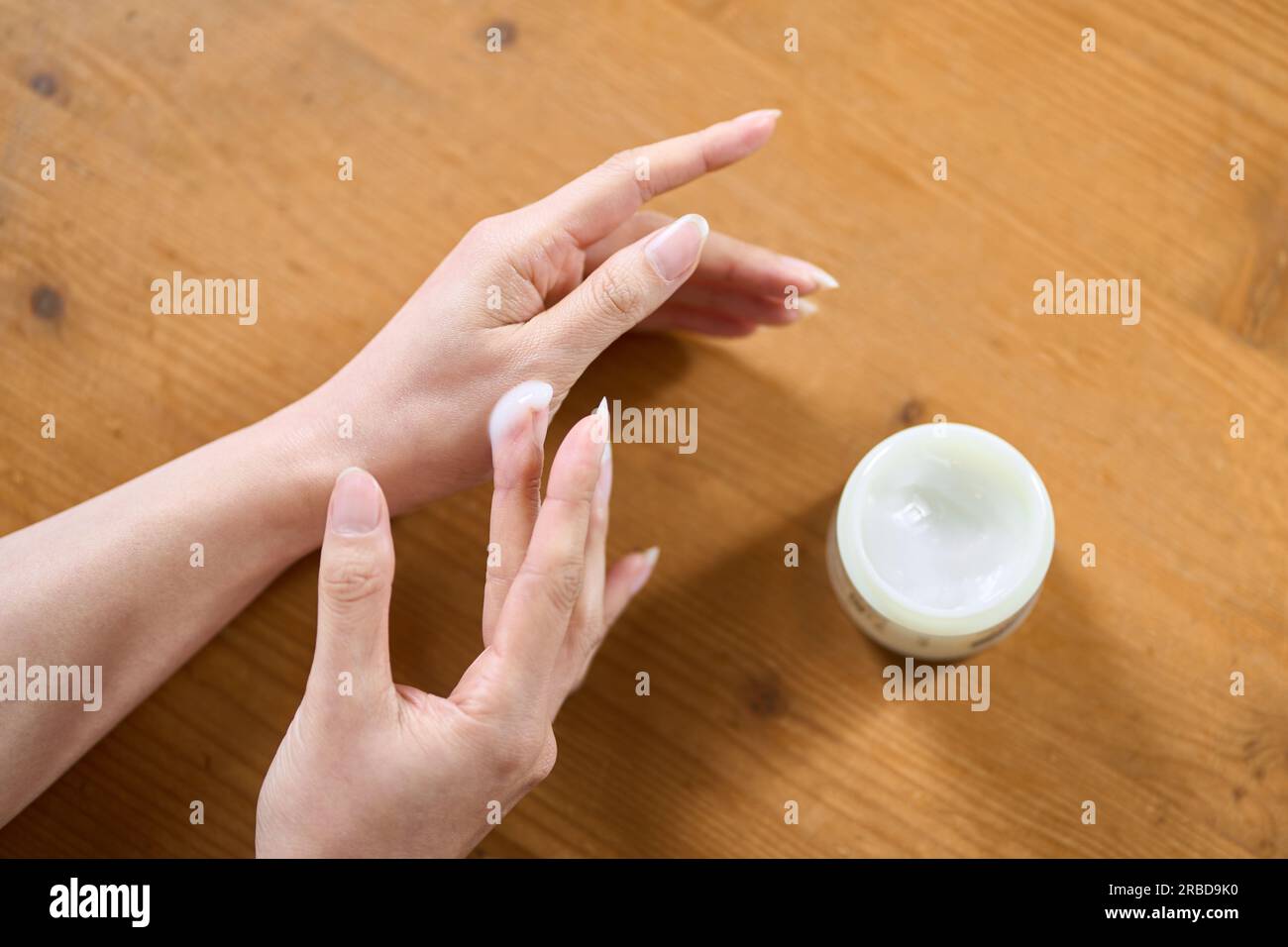 Hand of a woman applying cream with hand care Stock Photo - Alamy