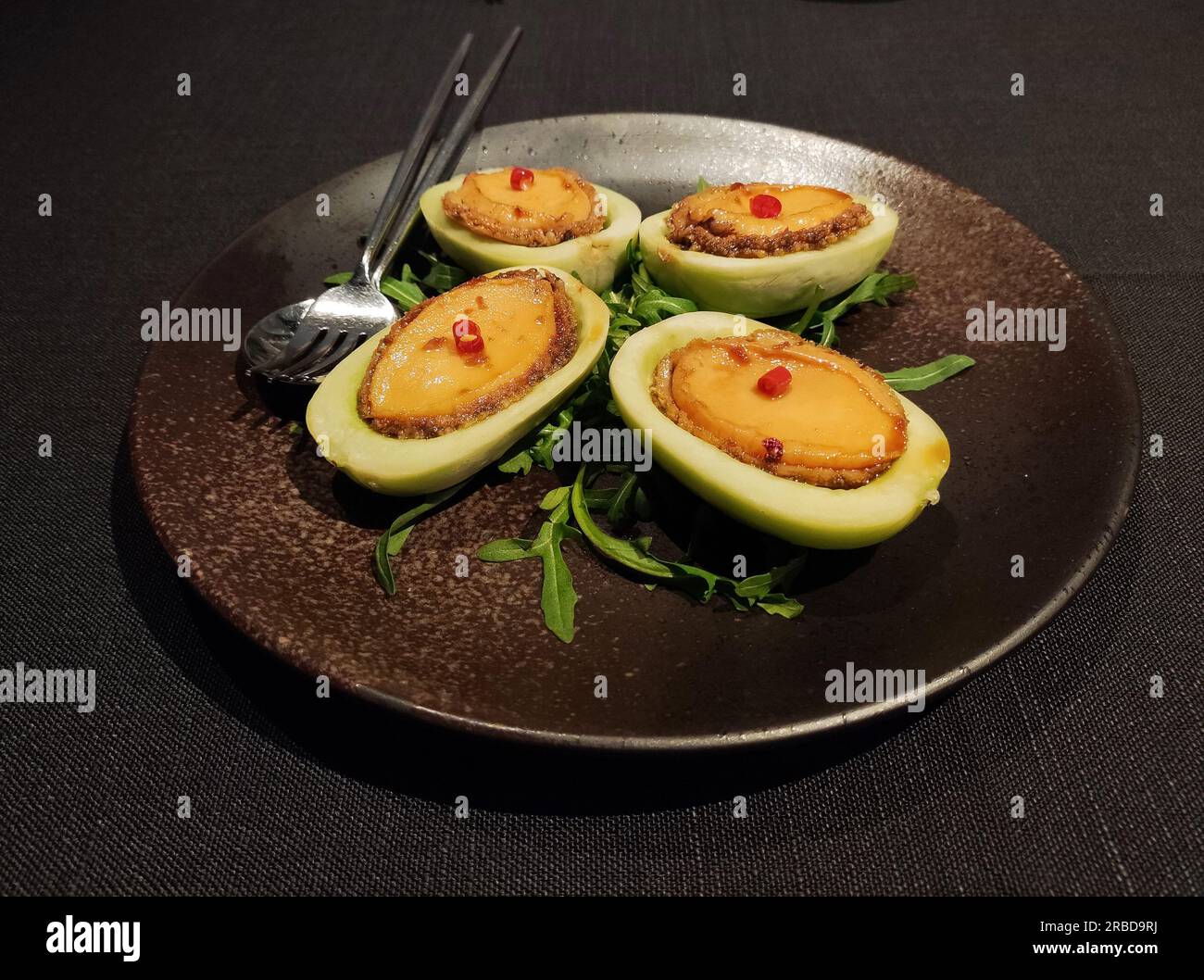 fresh braised abalone on the cucumber on the plate ready for eating ...