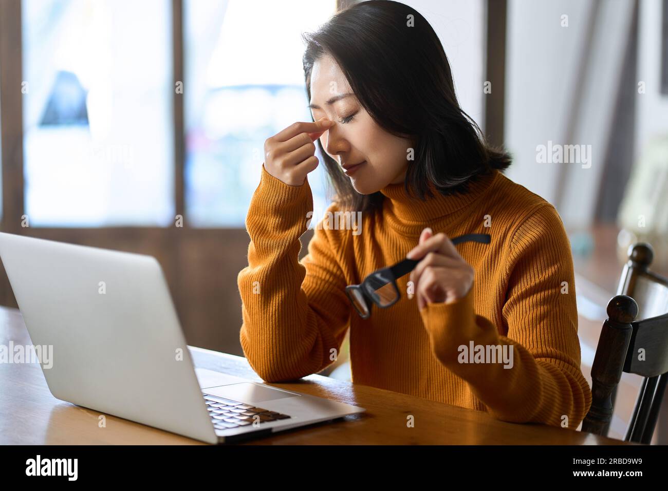 A woman whose eyes are tired from computer work Stock Photo - Alamy