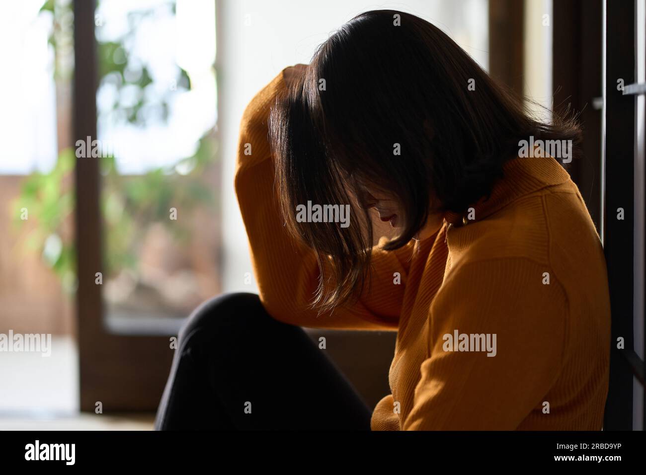 Anxious and depressed Asian woman Stock Photo - Alamy