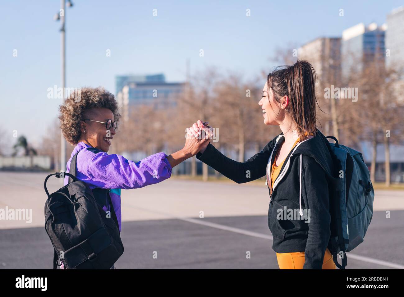 friends shaking hands before running in the city Stock Photo - Alamy