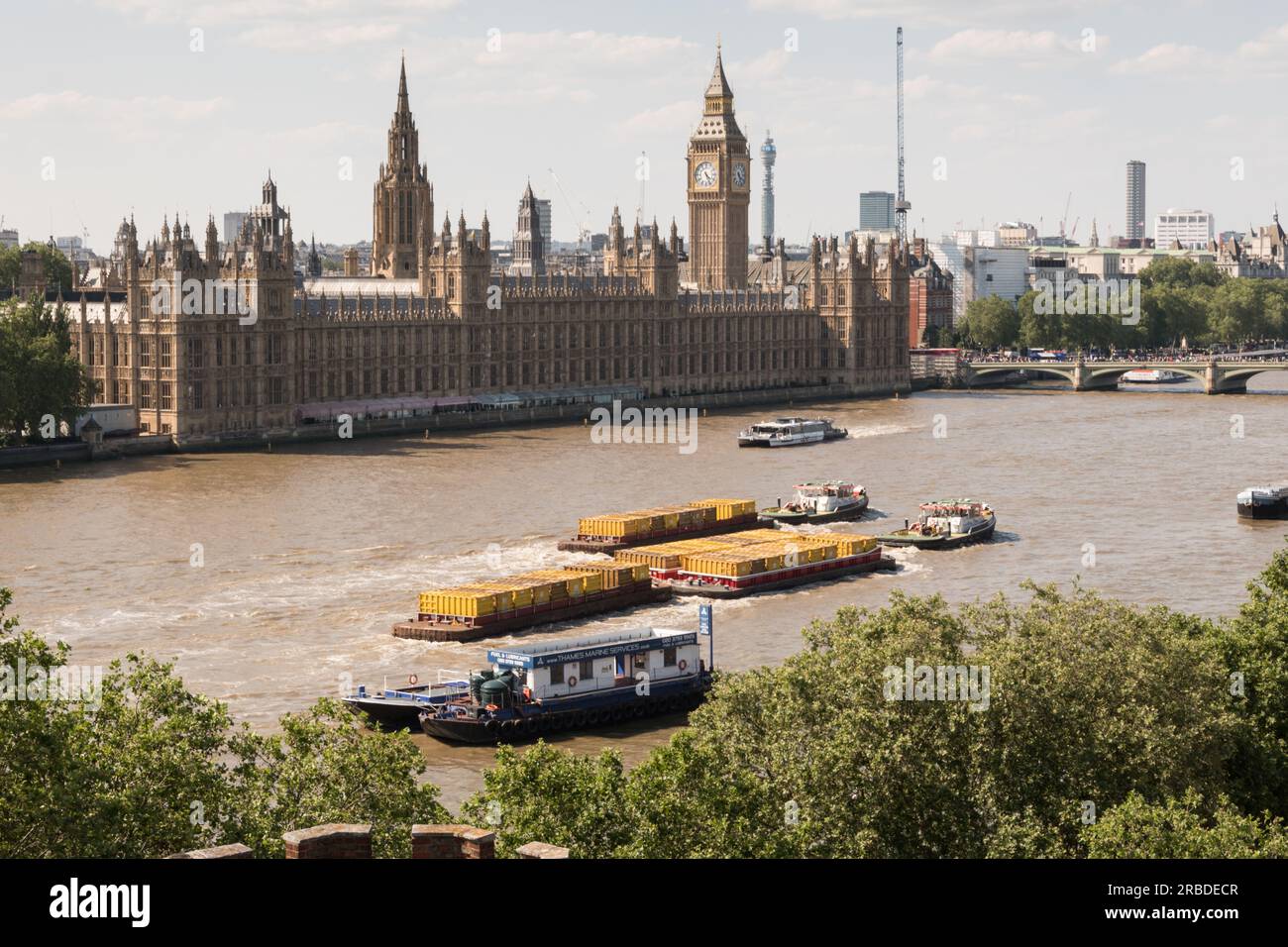 Cory tug boats transporting waste containers past the Houses of ...