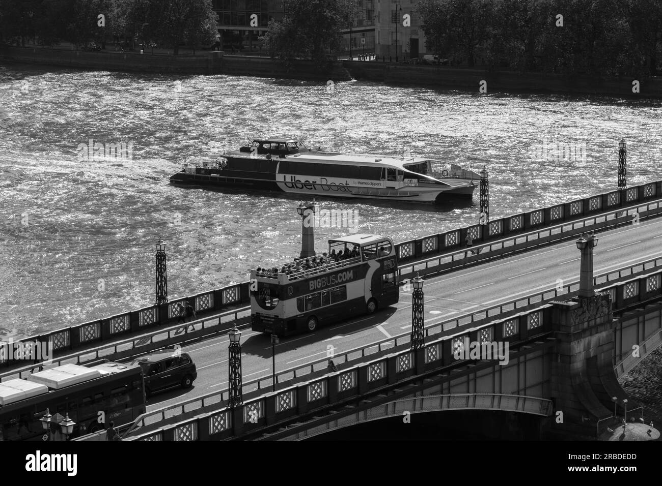 A Thames Clipper Uber Boat and BigBus.Com double decker tourist bus ...