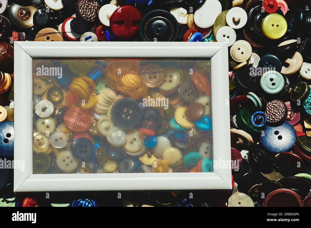 White blur frame on scattered different buttons of a tailor in a shop ...