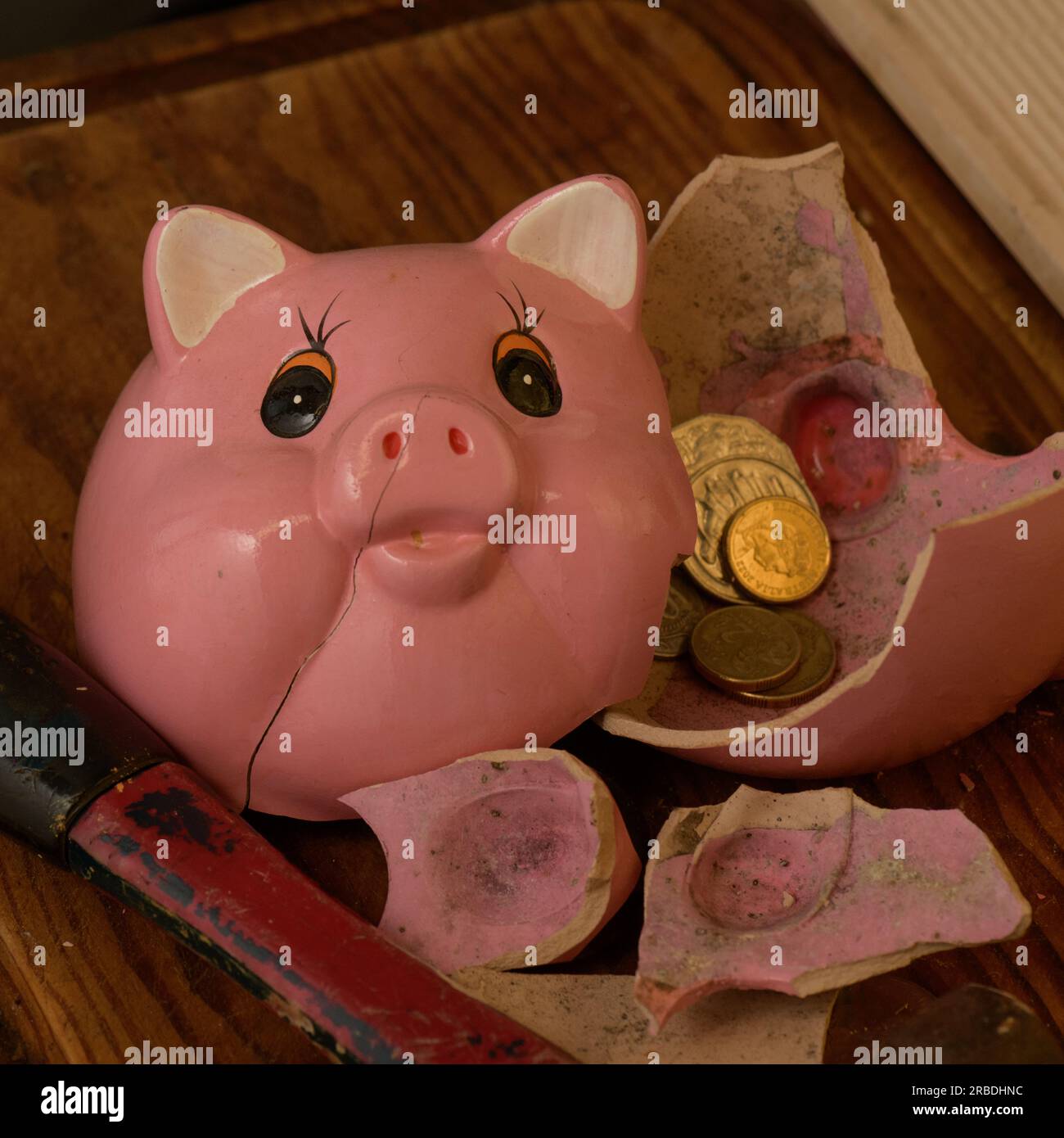 Breaking Open the Piggy Bank Stock Photo - Alamy