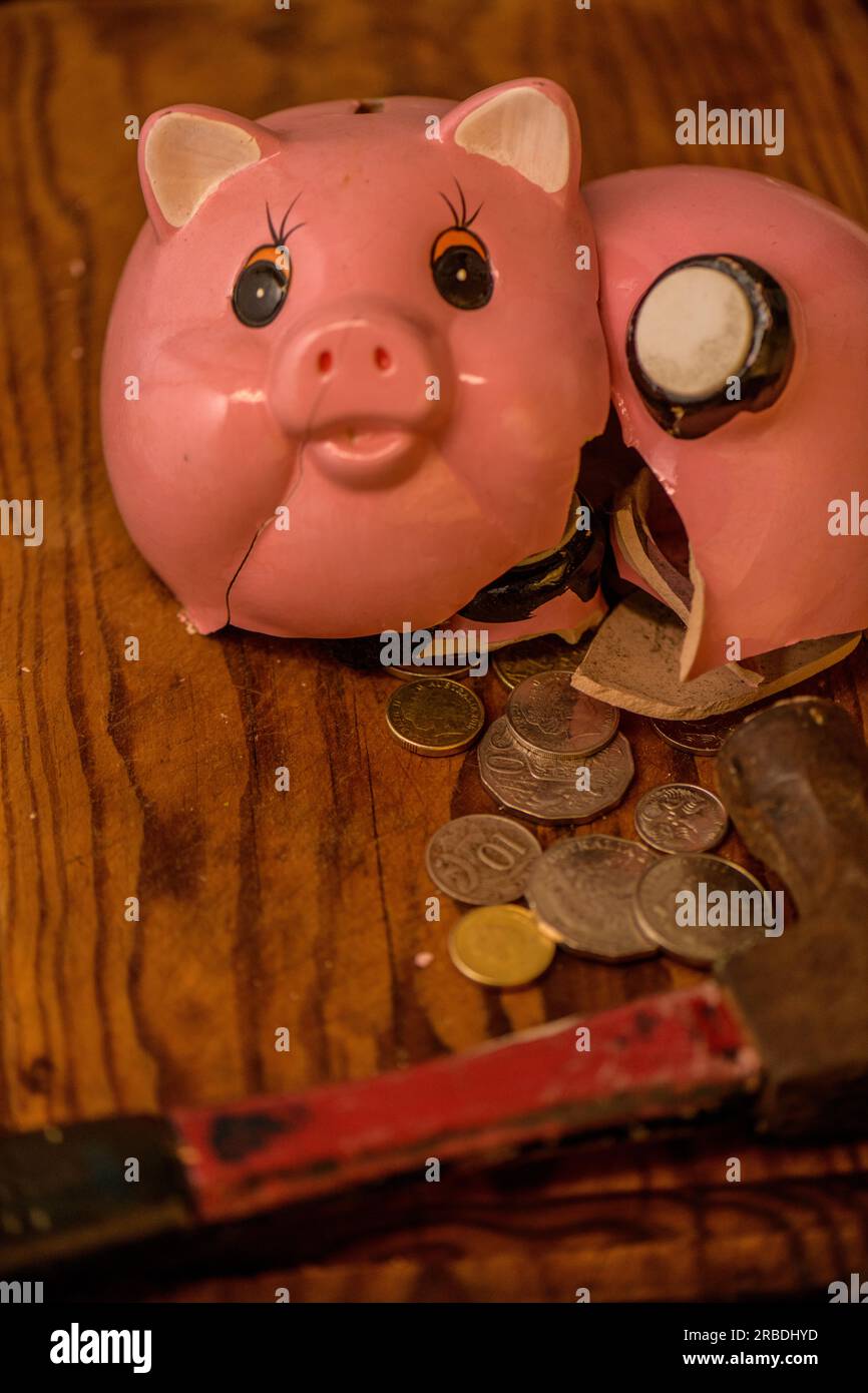 Breaking Open the Piggy Bank Stock Photo - Alamy